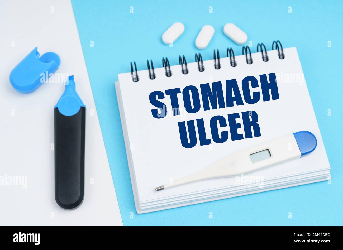 Medical diagnosis concept. On a white-blue surface are pills, a ...