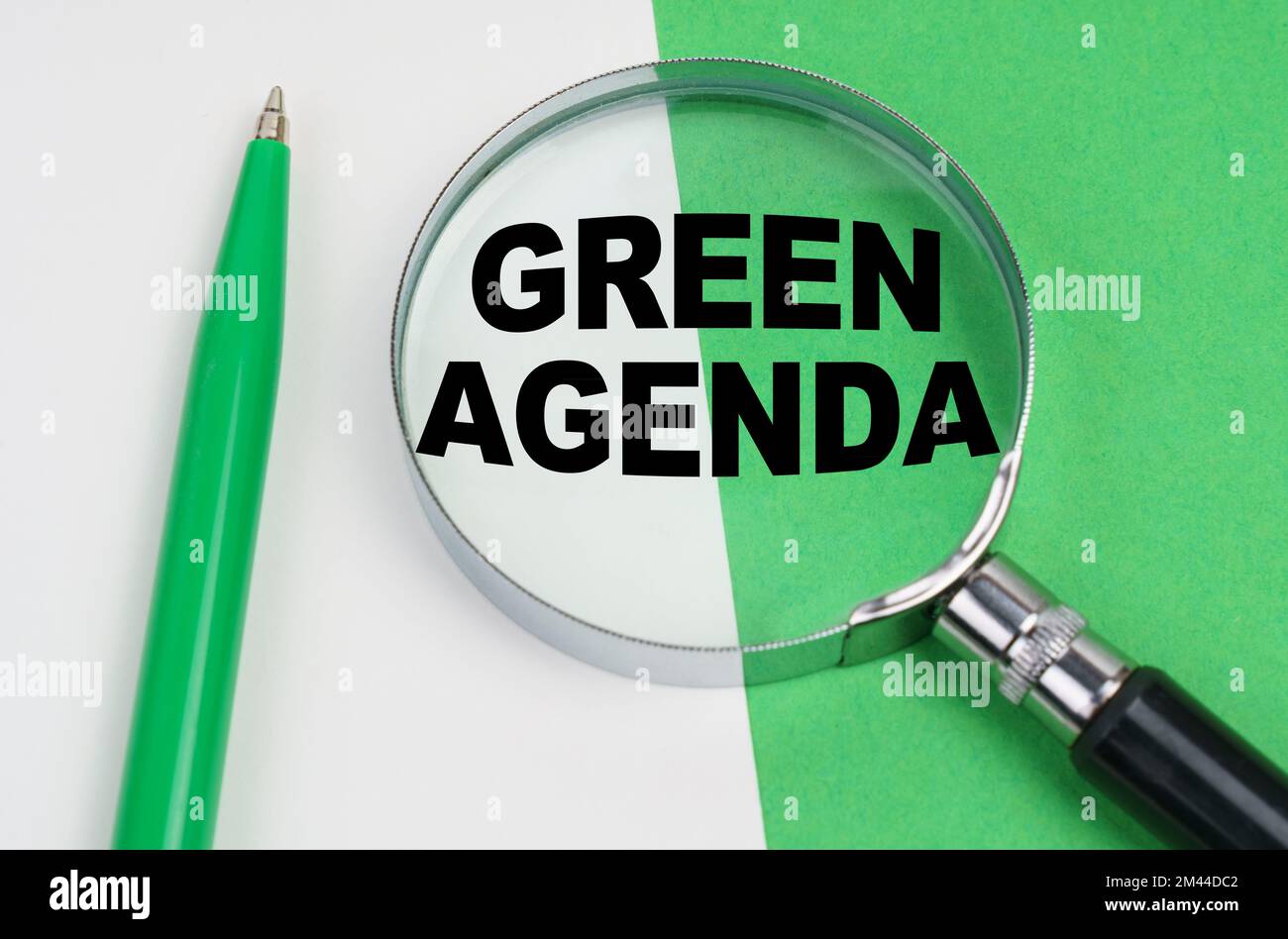 Ecological concept. On a white-green background lies a pen and a ...