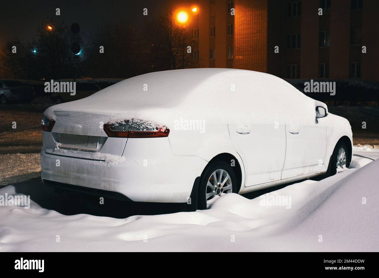 Car covered with snow on a night city street Stock Photo - Alamy
