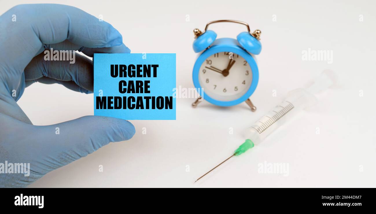 Medicine concept. On the table is a syringe and an alarm clock, in his ...