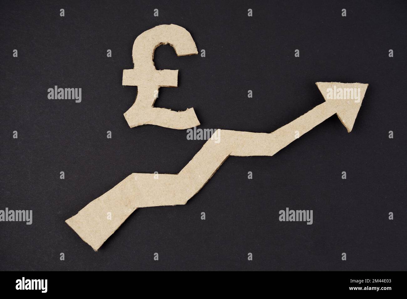 The concept of economic growth. On a black surface, a graph with an up ...