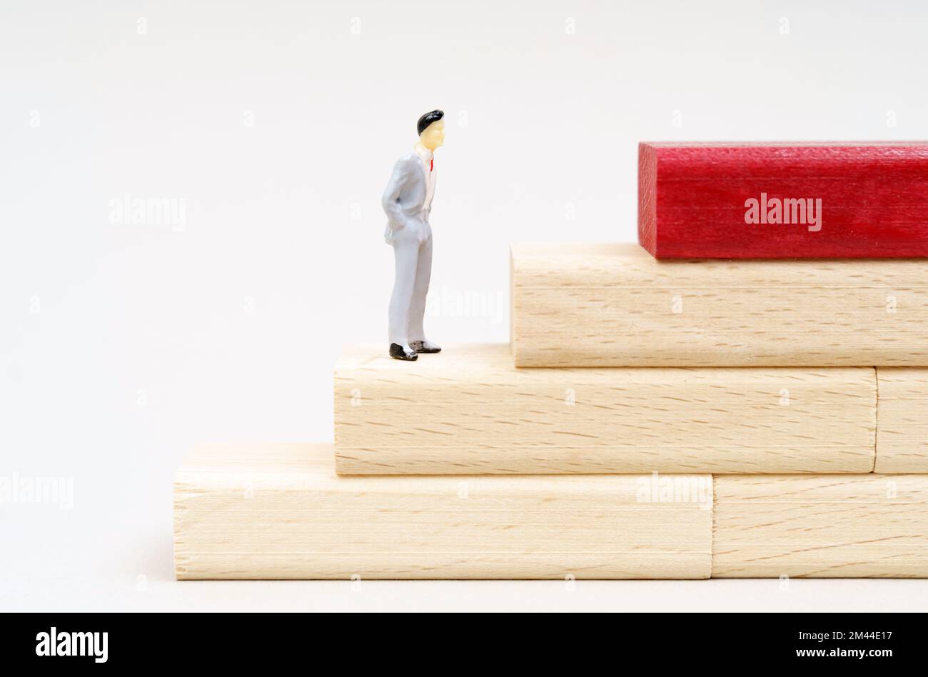Career concept. On a white surface, a miniature figure of a person ...