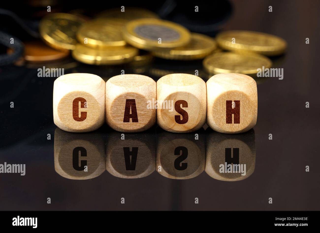 Business and economy concept. On a black reflective surface are coins ...