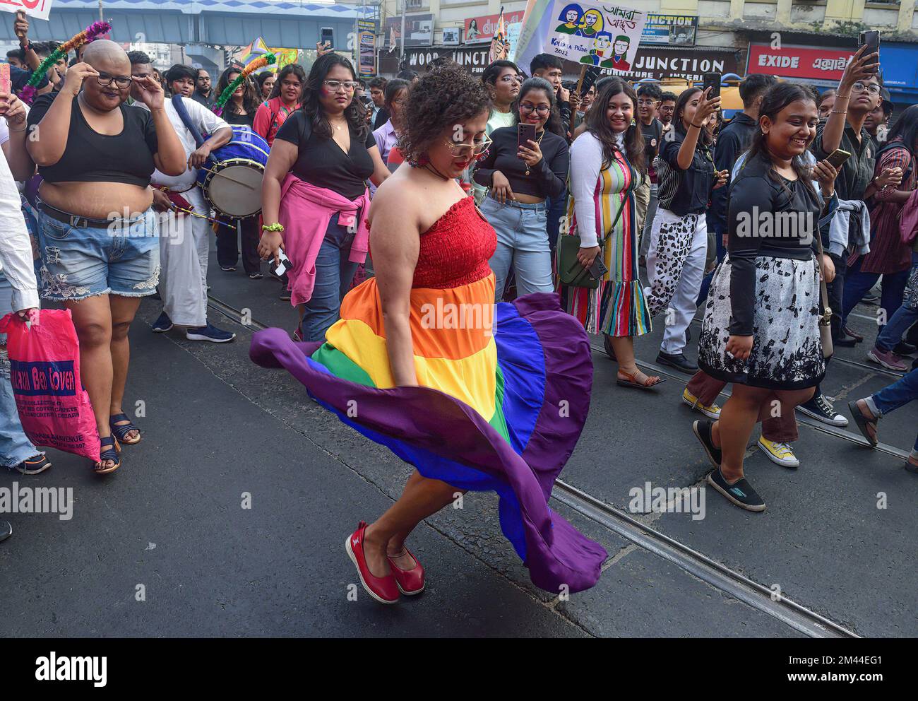 Kolkata, India. 18th Dec, 2022. A participant in a rainbow dress dances ...