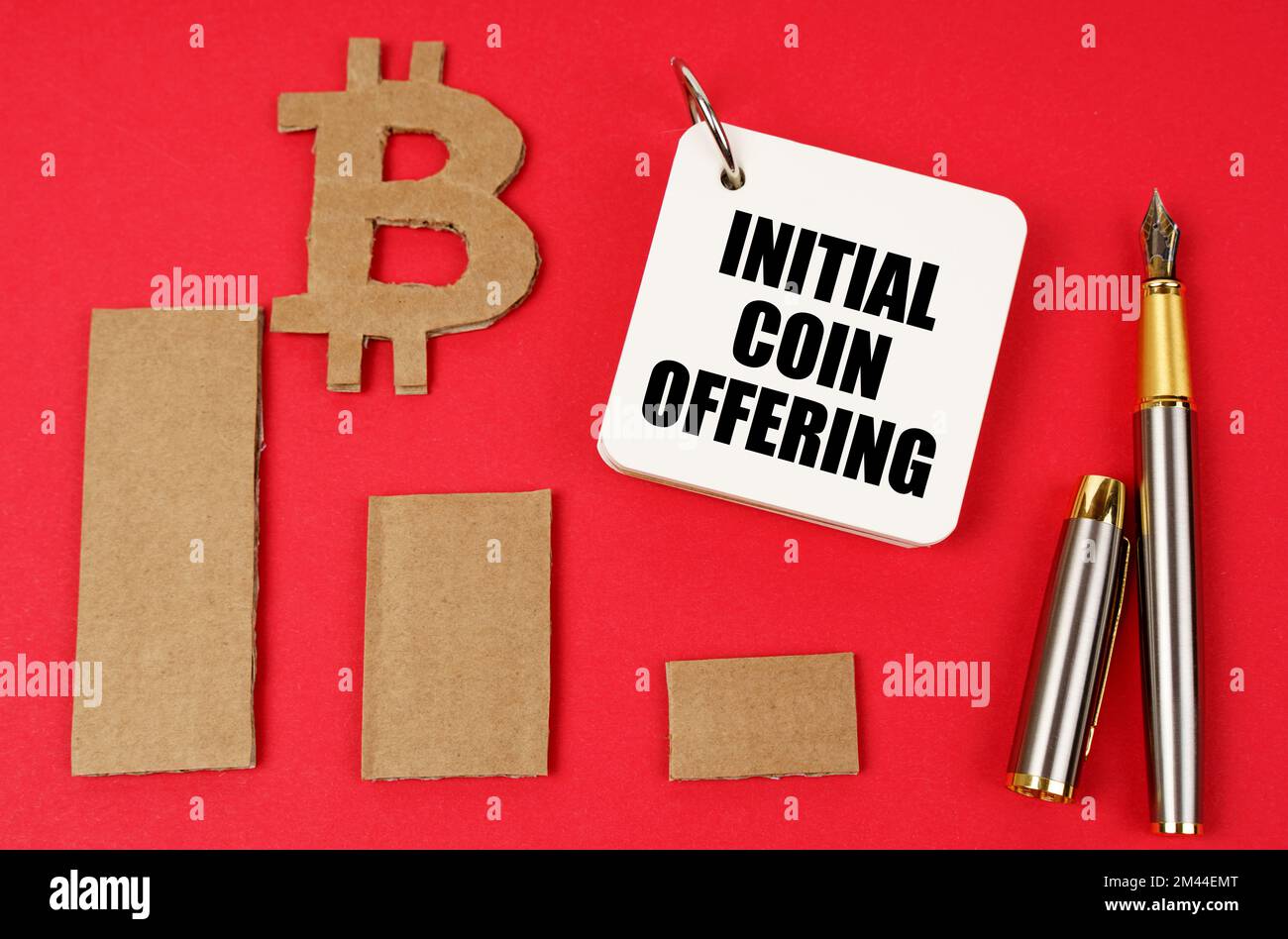 Business and bitcoin concept. On a red surface lie a bitcoin symbol, a ...