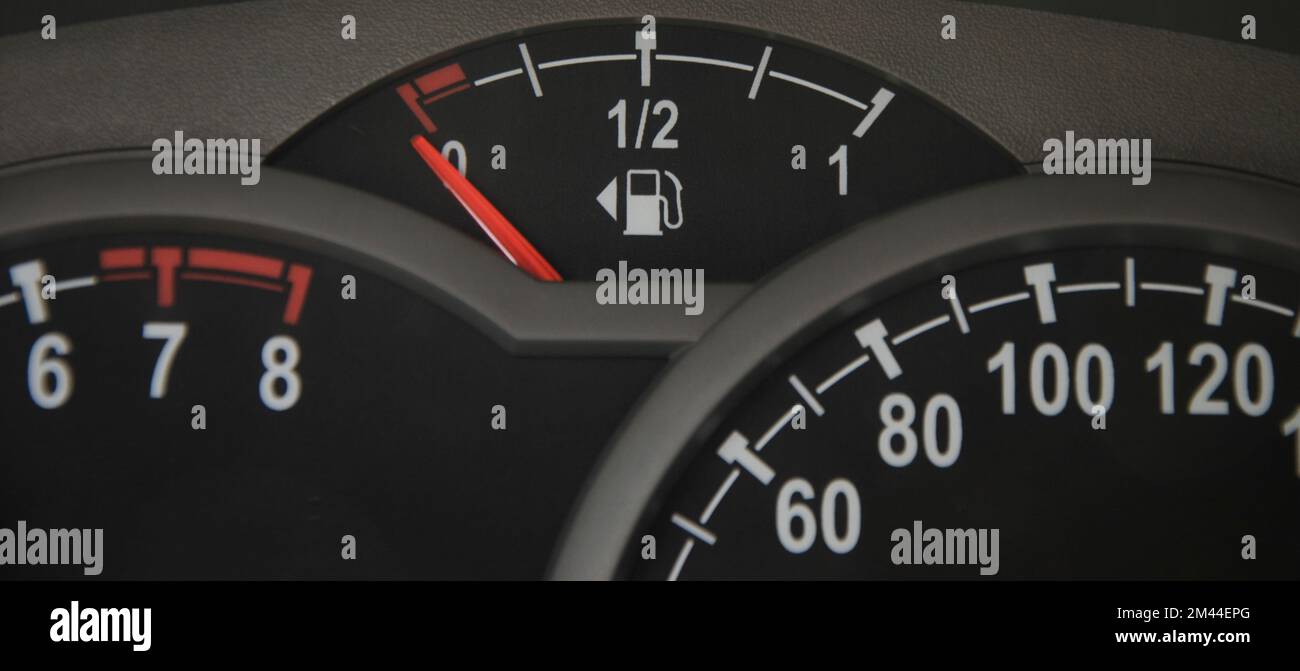 The car dashboard with empty gasoline tank, rev counter and speedometer ...