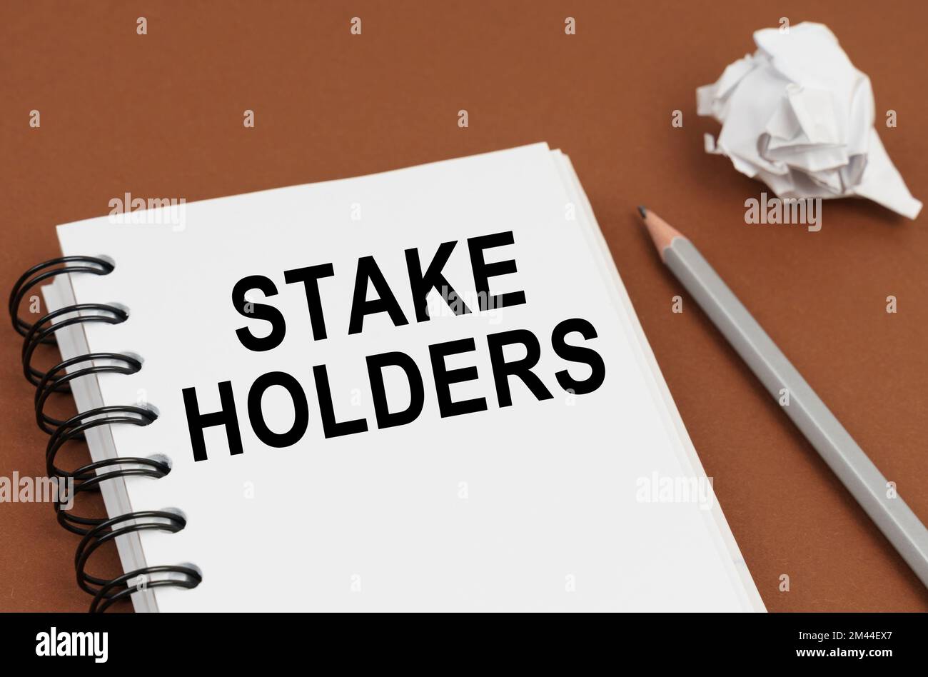 Business and finance concept. On a brown surface lies a pen, crumpled ...