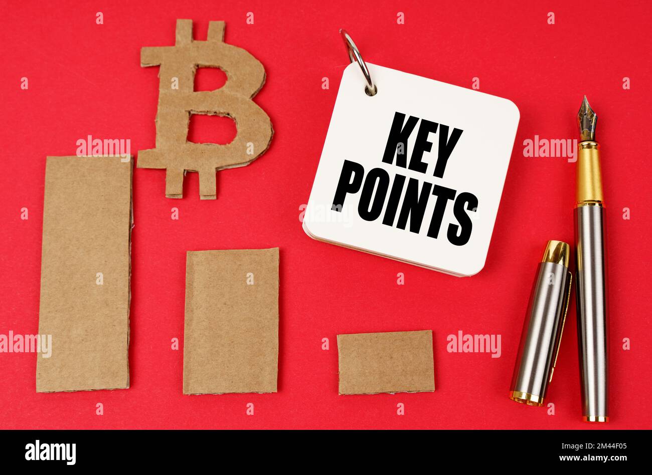 Business and bitcoin concept. On a red surface lie a bitcoin symbol, a ...