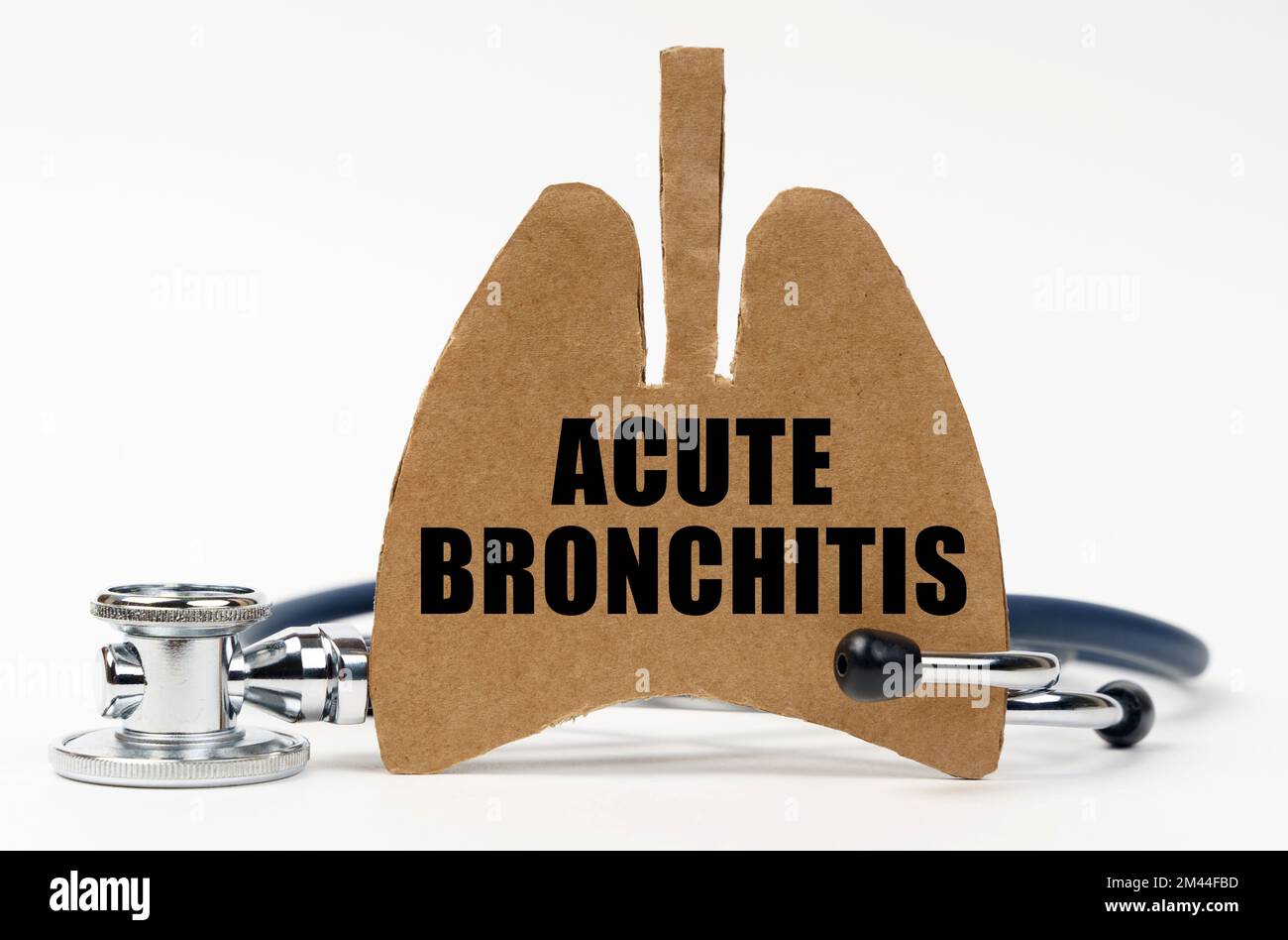 Medical concept. On a white surface are a stethoscope and a cardboard ...