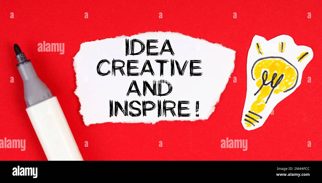 Business concept and idea. On a red surface lie a marker, a drawing of ...