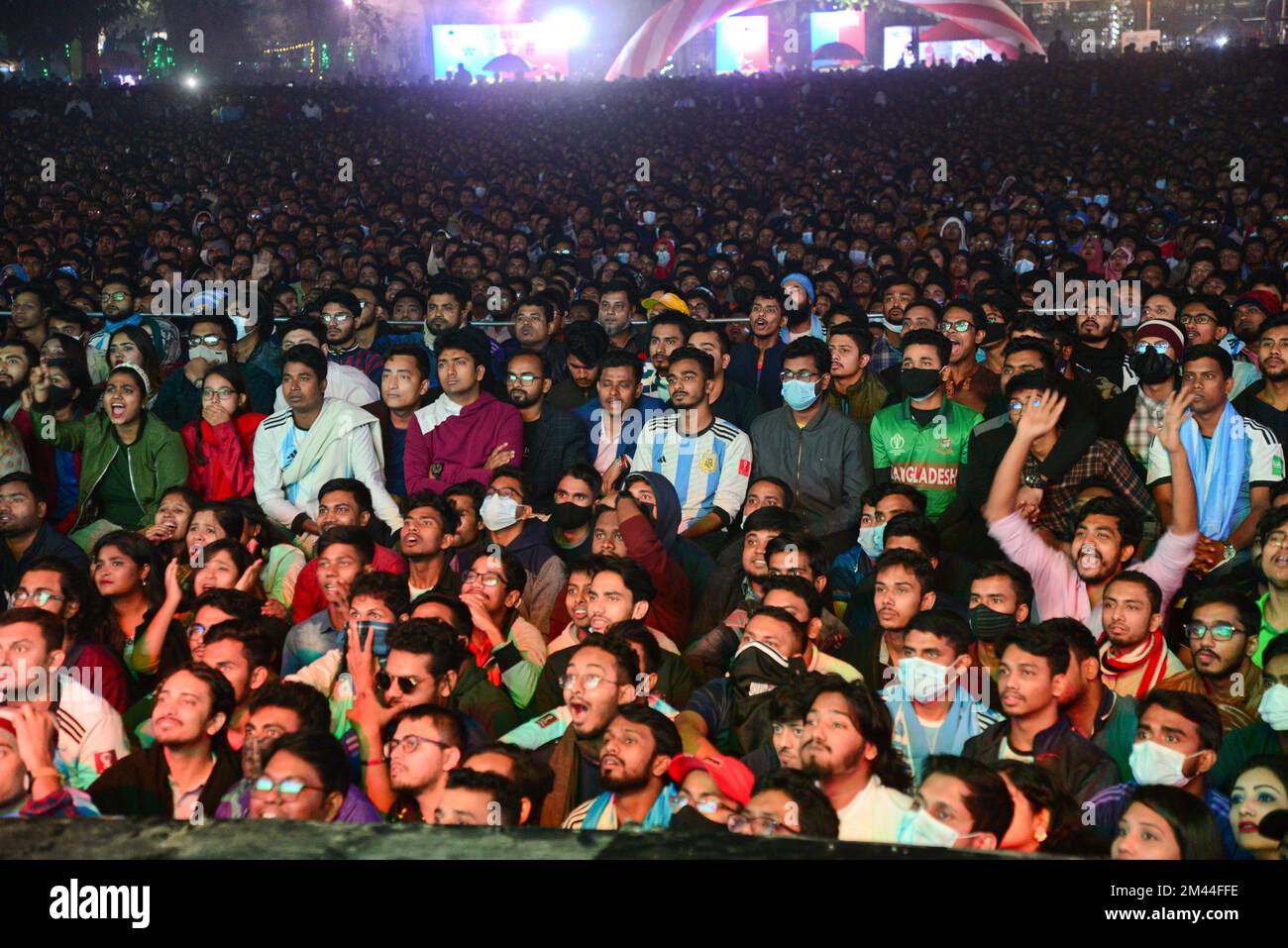 Bangladeshi soccer fans watch on a big screen a public broadcast of the ...