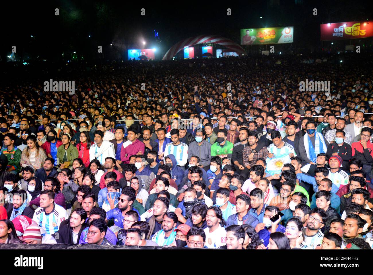 Bangladeshi soccer fans watch on a big screen a public broadcast of the ...