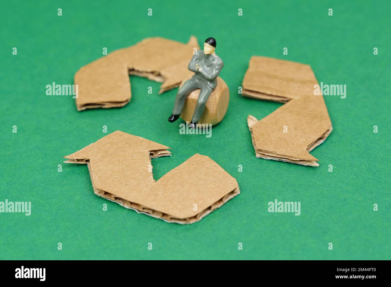 Ecological concept. On the green surface lies the symbol of recycling ...