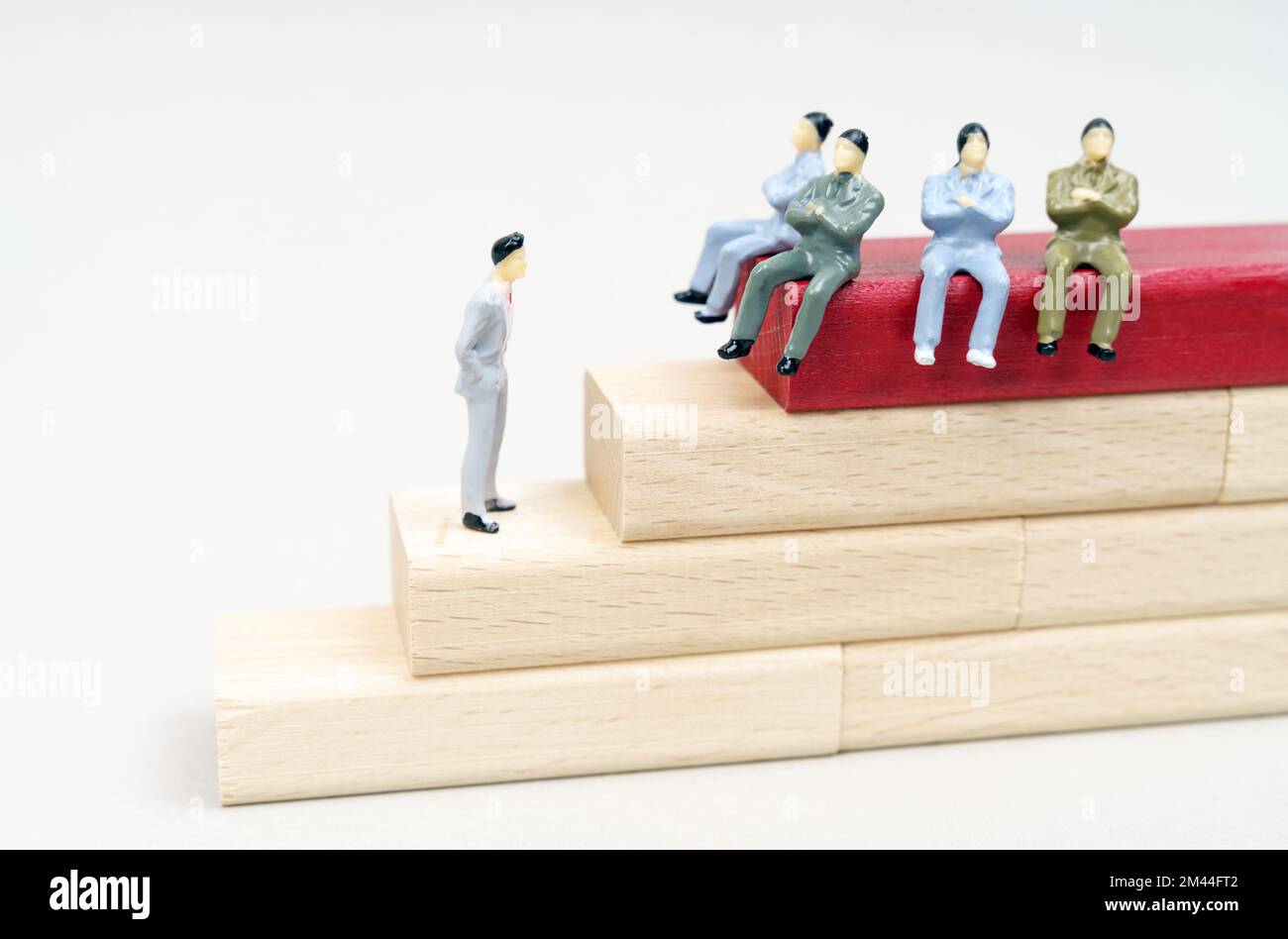 Corruption concept. On a white surface, a miniature figure of a person ...