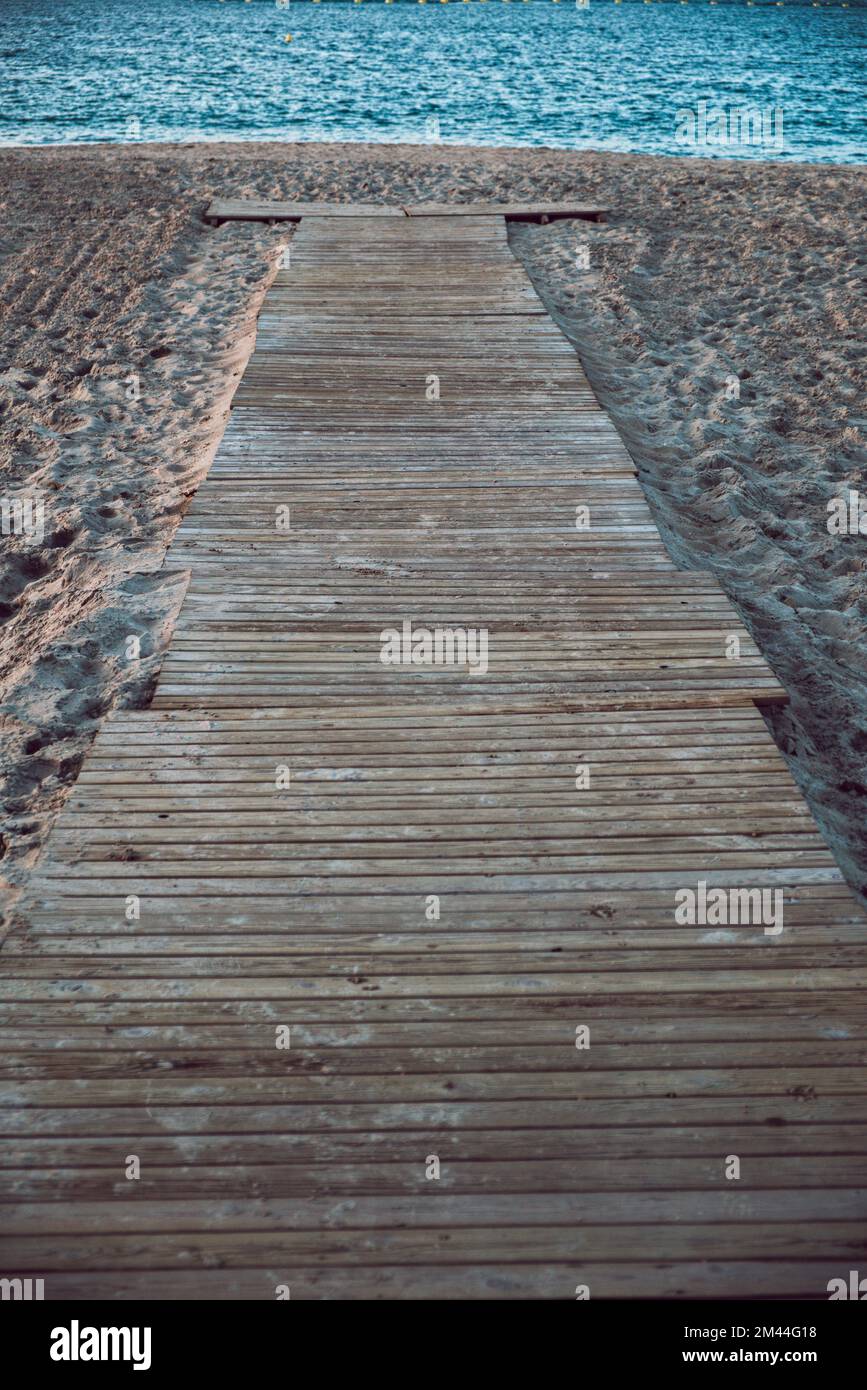 A wooden walkway on the sandy beach Stock Photo - Alamy