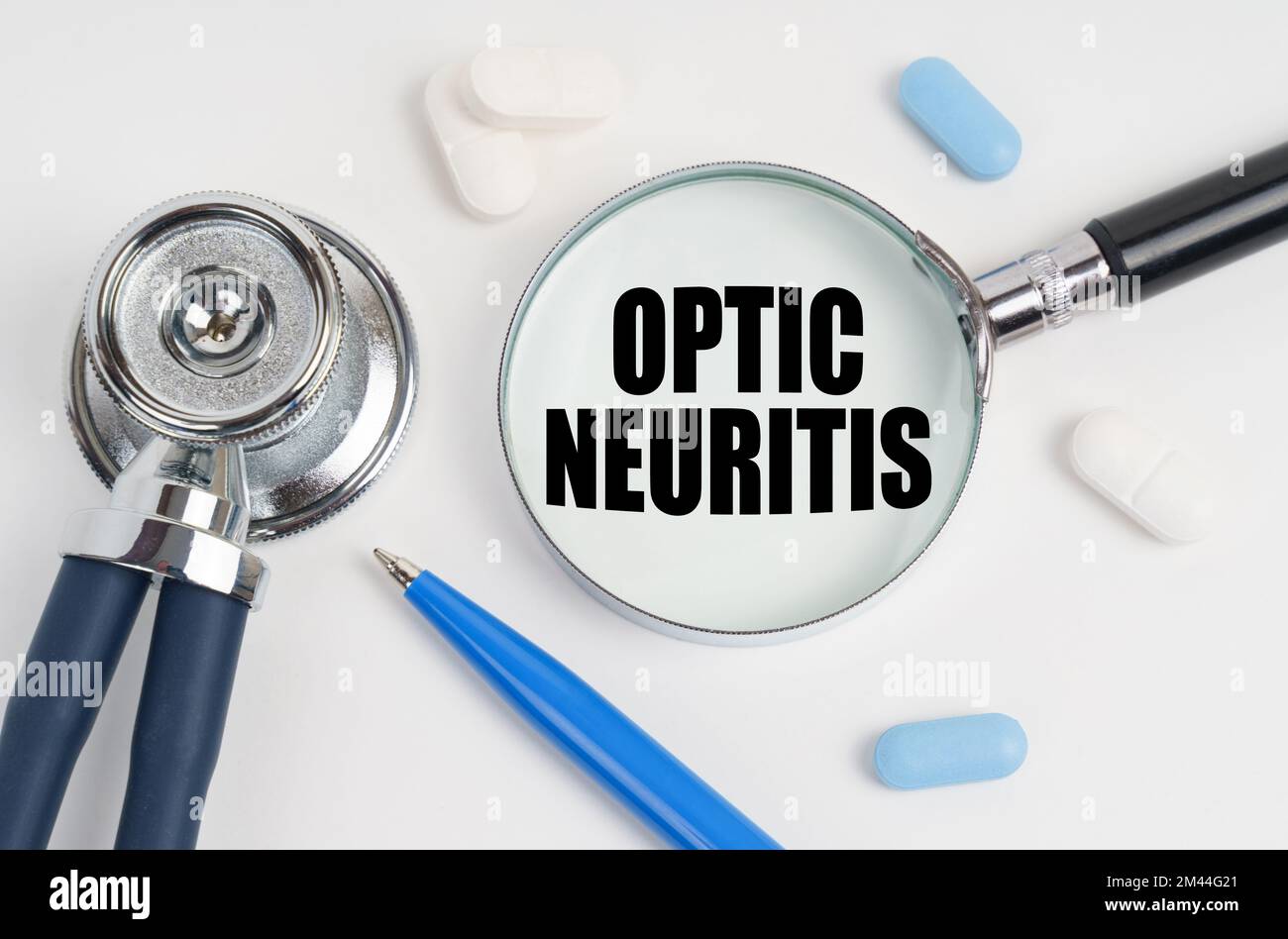 Medicine and health concept. On a white surface lie pills, a pen, a ...