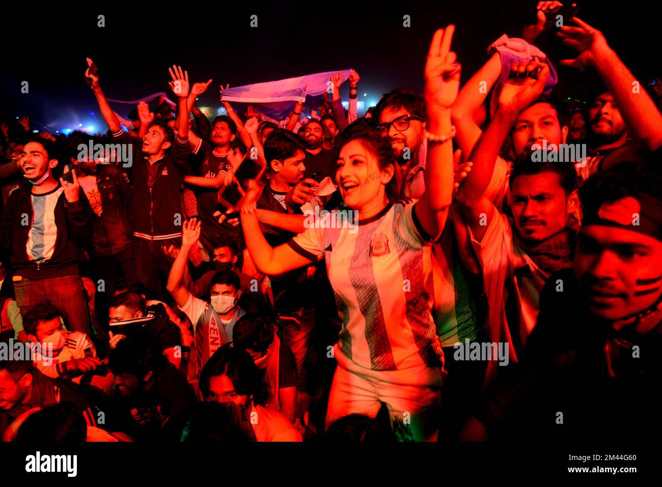 Bangladeshi Argentinian supporters react as they watch the final football match of the Qatar ...