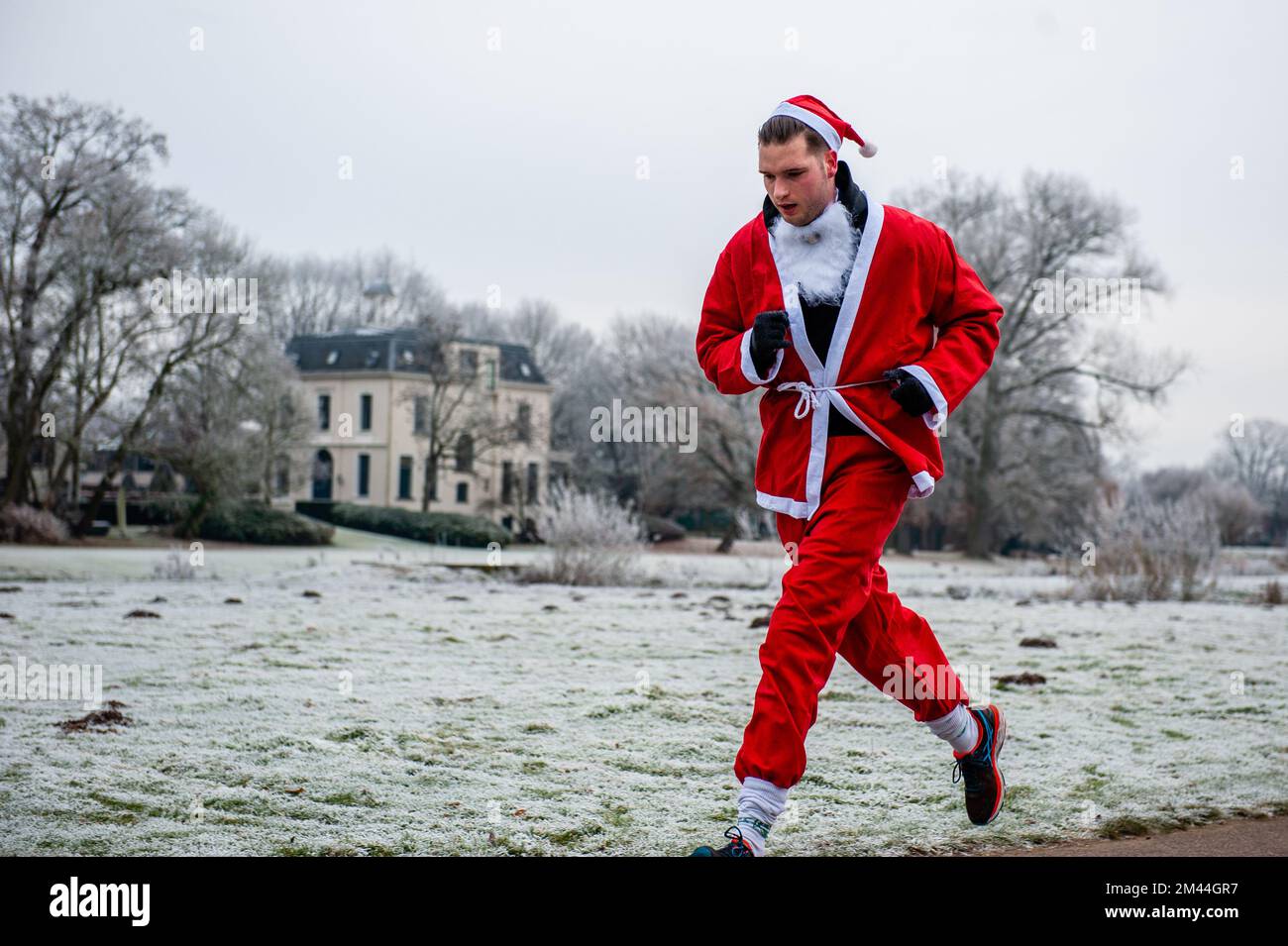 The first runner wearing his Santa costume is seen running the last ...