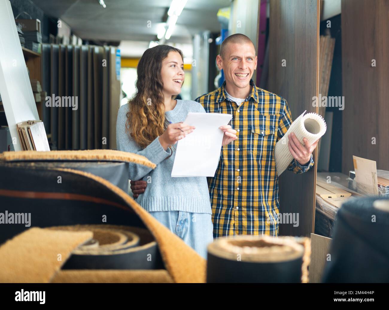 Woman and man discussing shopping list in building store Stock Photo ...