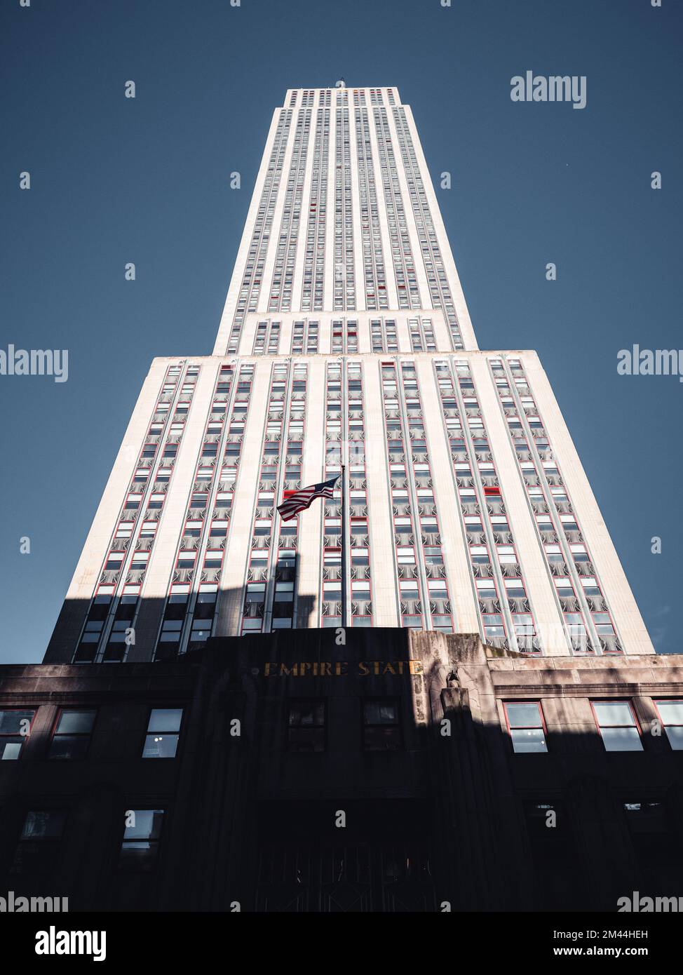 A vertical low-angle shot of the Empire State Building in New York ...