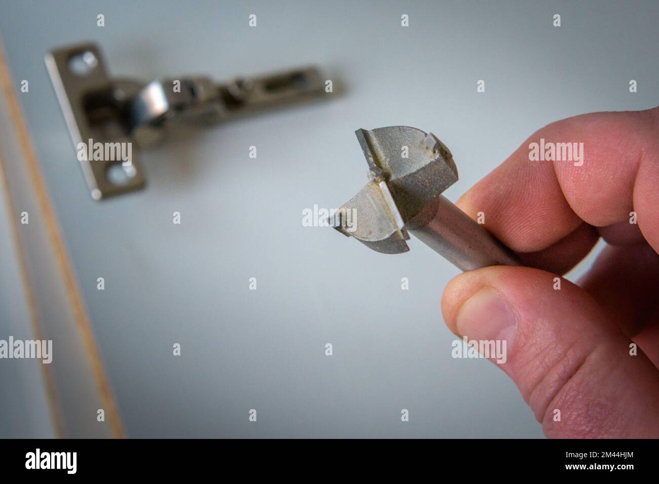 Special tool for installing furniture fittings. hinge fixed on modern ...