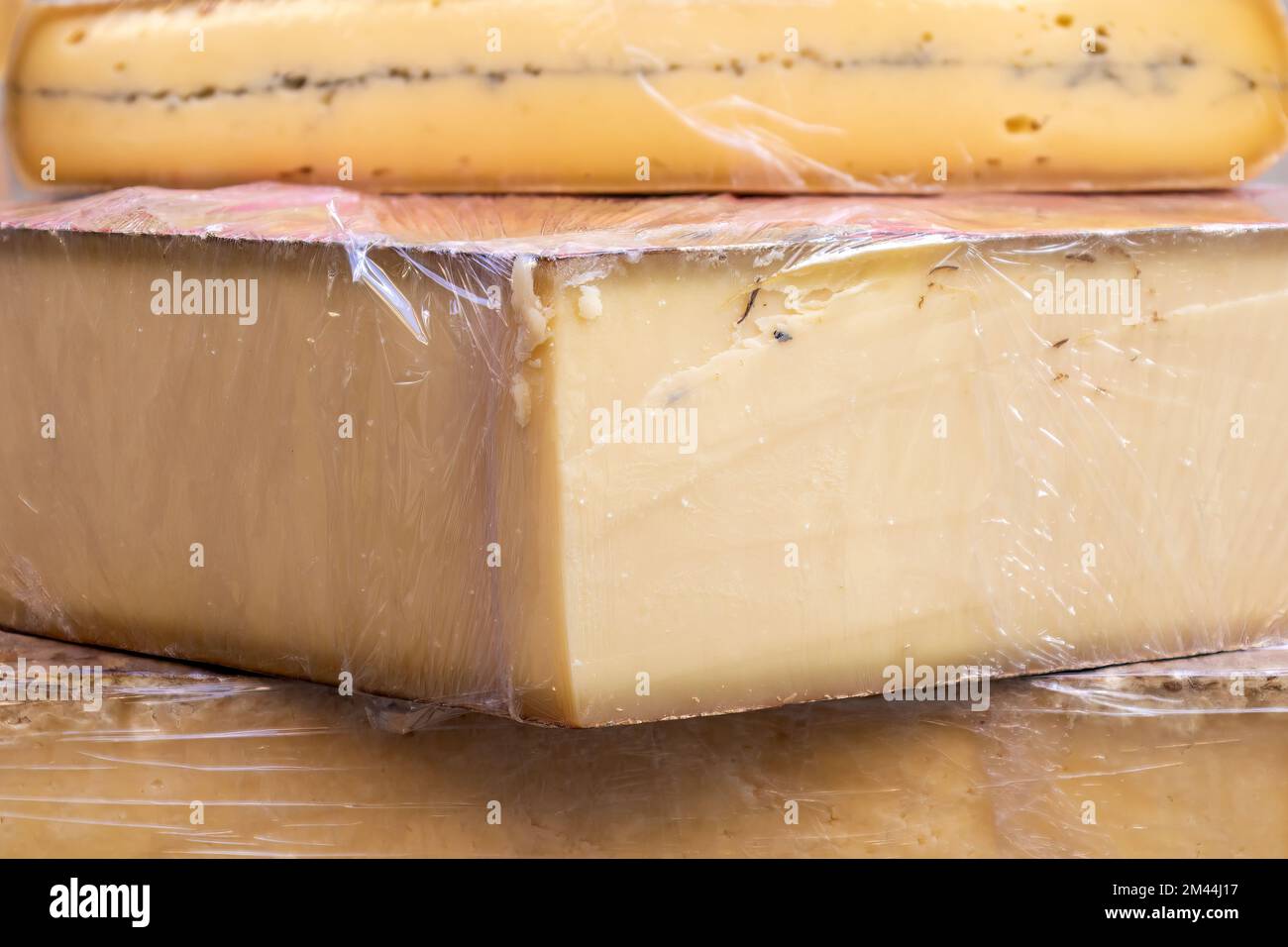 closeup in horizontal view of several large portions of cheese wrapped ...