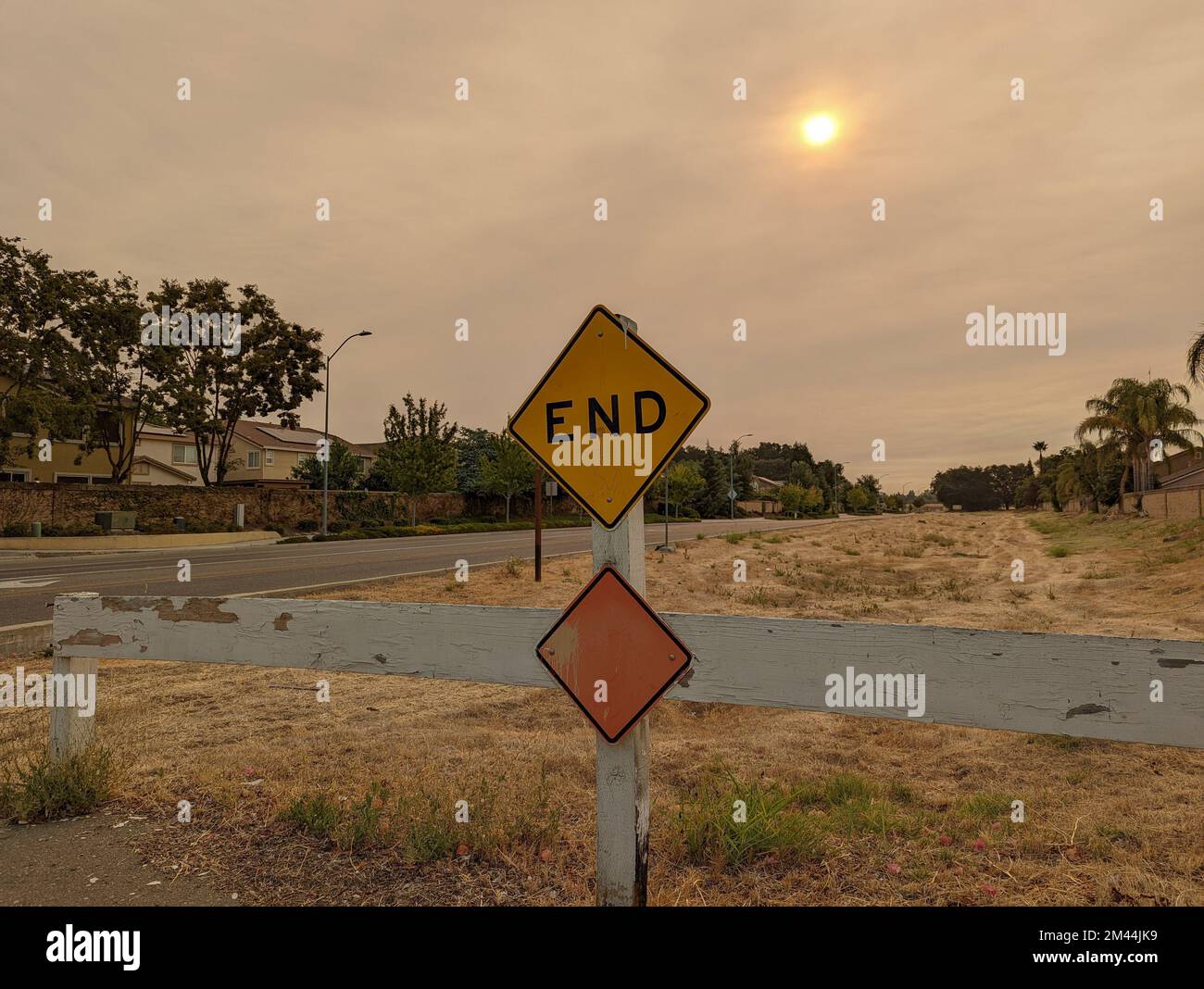 A close-up shot of a road sign under the wildfire smoke sky Stock Photo ...