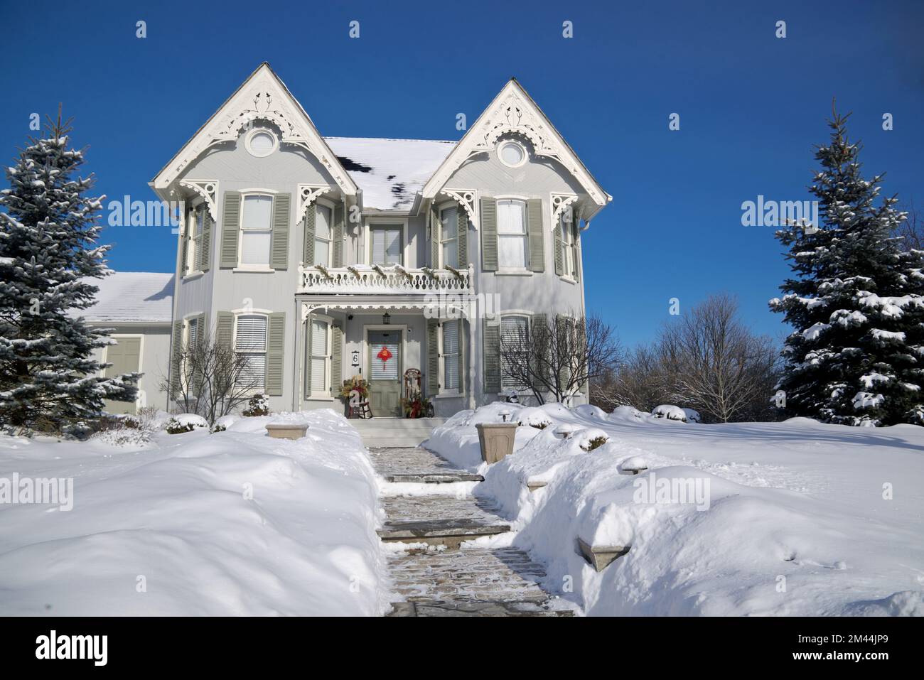 Winter landscape of Victorian style house exterior with deep snow in ...