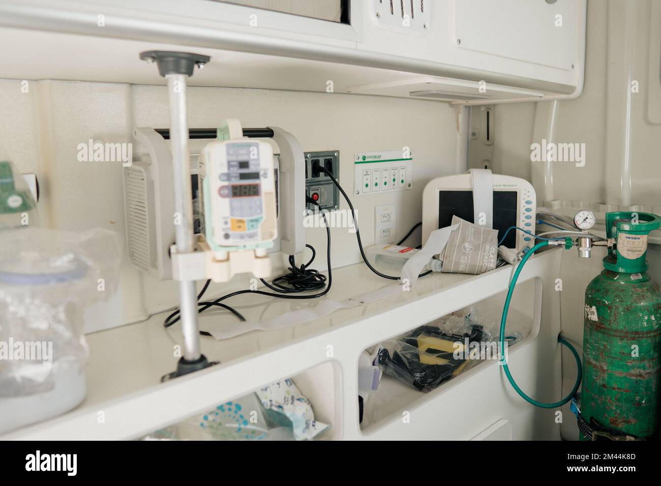 A green medical oxygen cylinder with other hospital equipment inside an ...