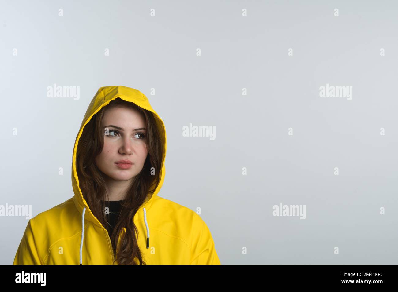 Sadness In The Rain Portrait Of A Girl Dressed In Raincoat Posing With
