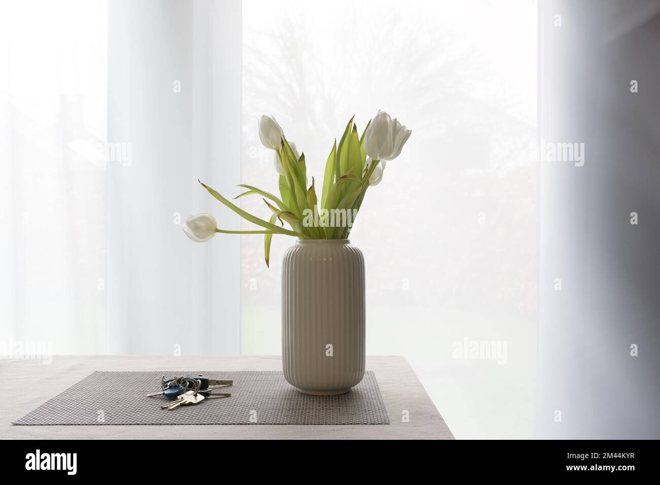 Withering flowers in a vase and keys left on the table. Concept Stock ...