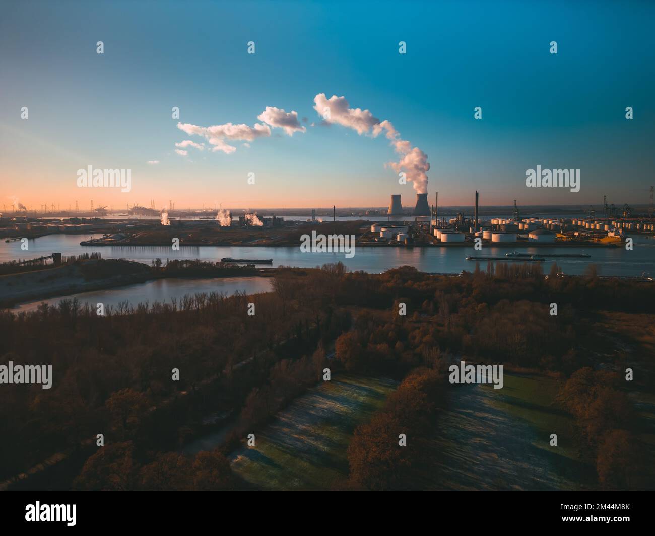 Aerial shot of industrial port with refinery, nuclear power plant and ...