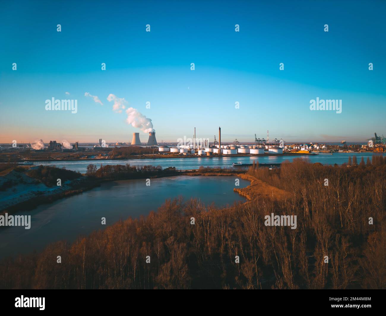 Aerial shot of industrial port with refinery, nuclear power plant and ...