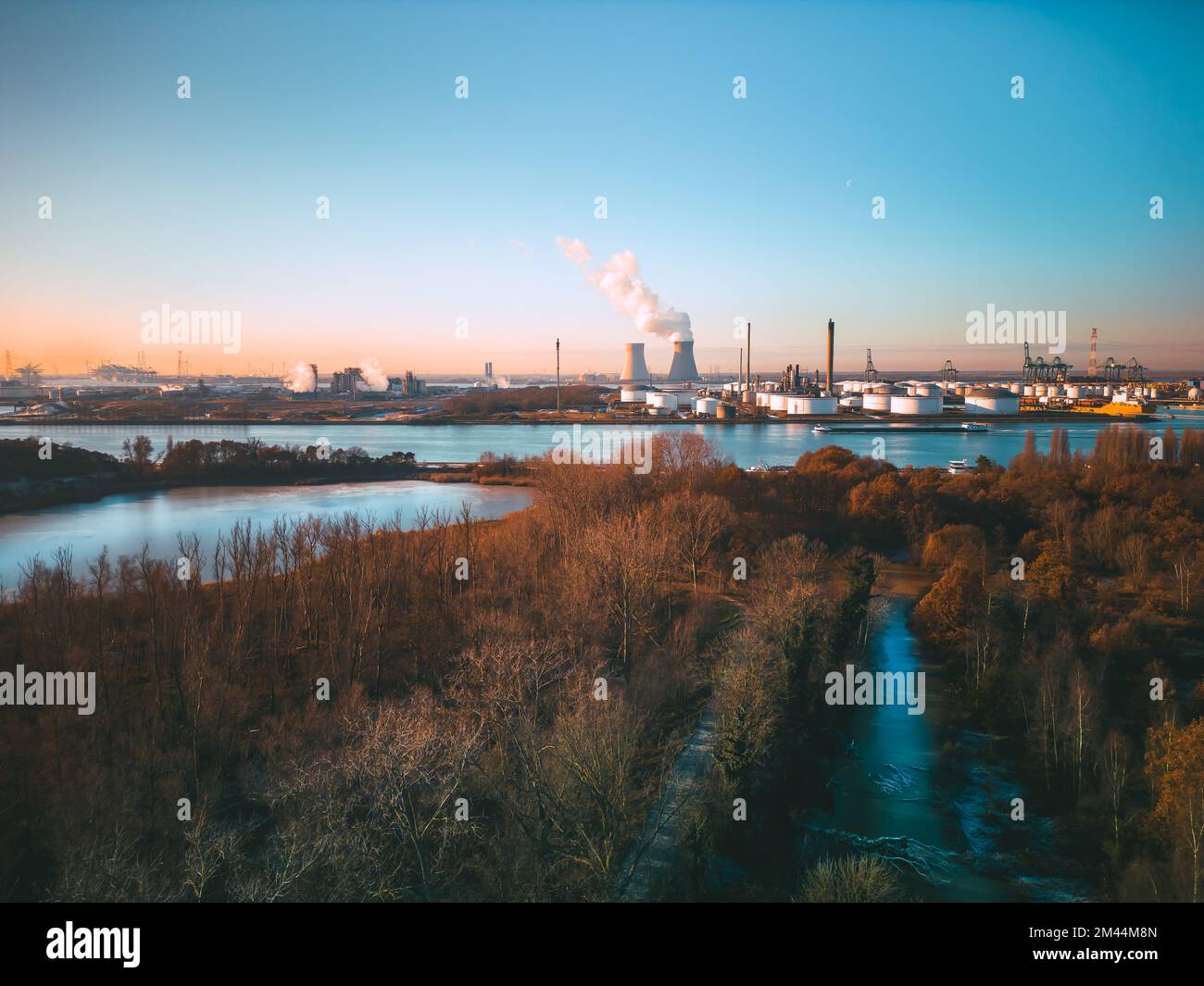 Aerial shot of industrial harbour with refinery, nuclear power plant ...