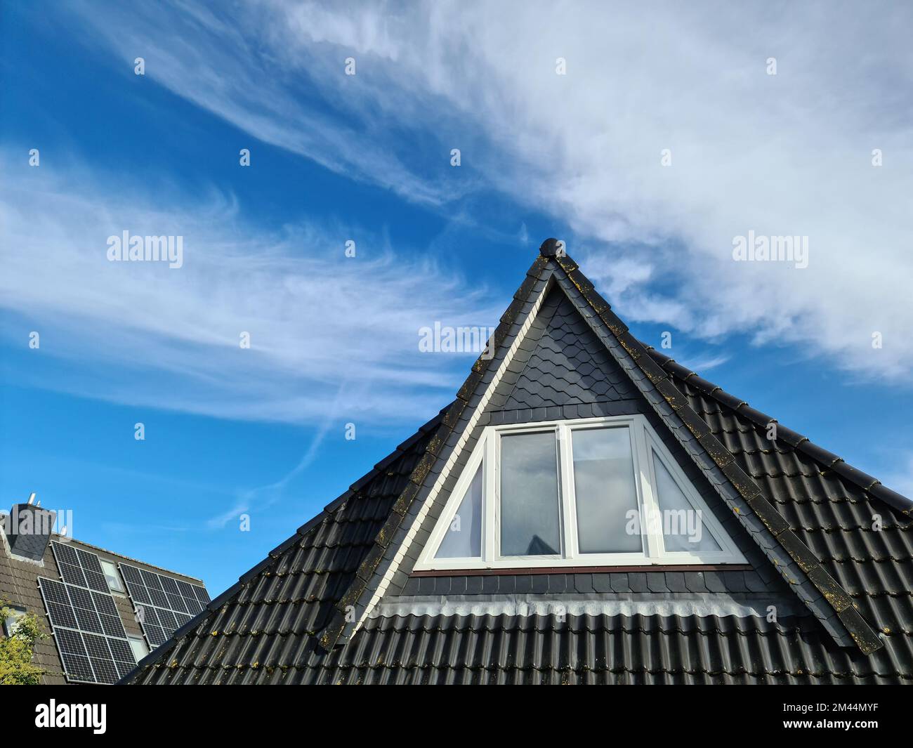 Open roof window in velux style with black roof tiles Stock Photo - Alamy