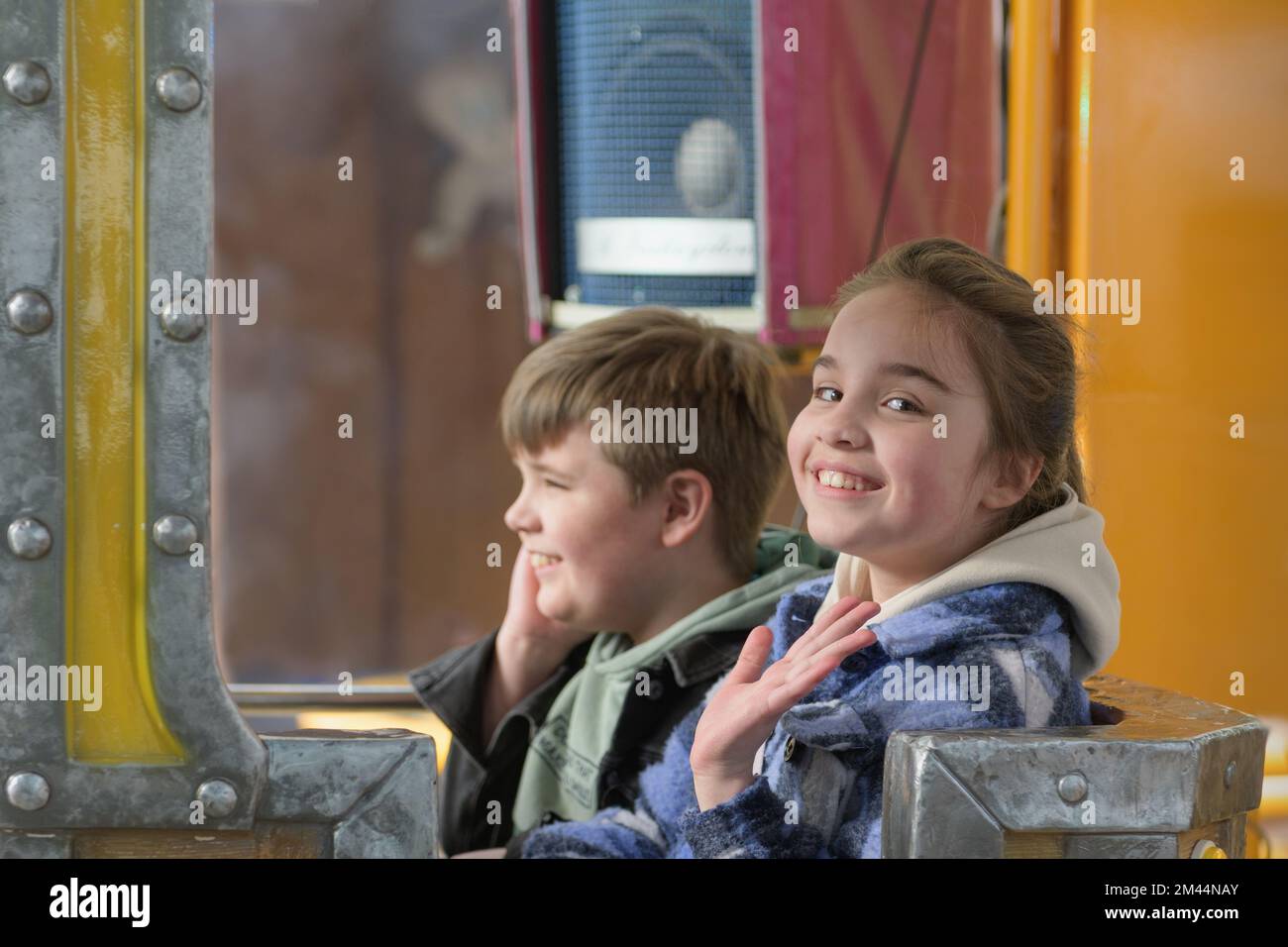 Teenage girl and boy. On the carousel in the amusement park Stock Photo ...