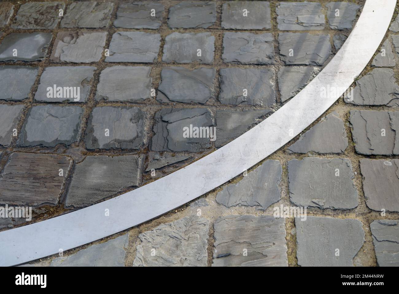 An example of a metal arc insert in a stone pavement Stock Photo - Alamy