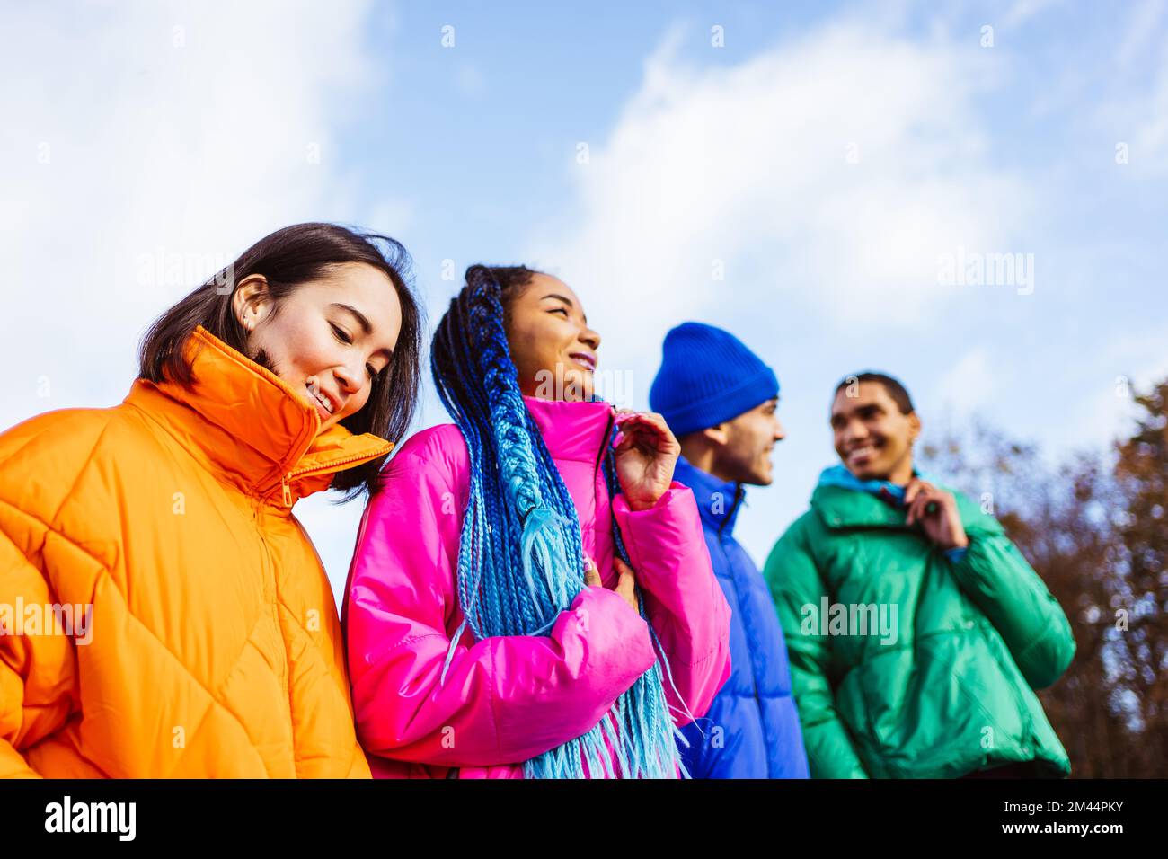 Multiracial group of young happy friends meeting outdoors in winter ...