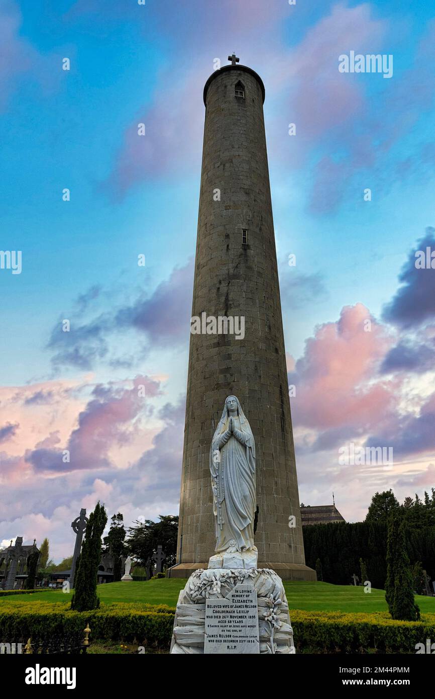 Statue of the Virgin Mary in front of tall round tower, OConnell Tower ...