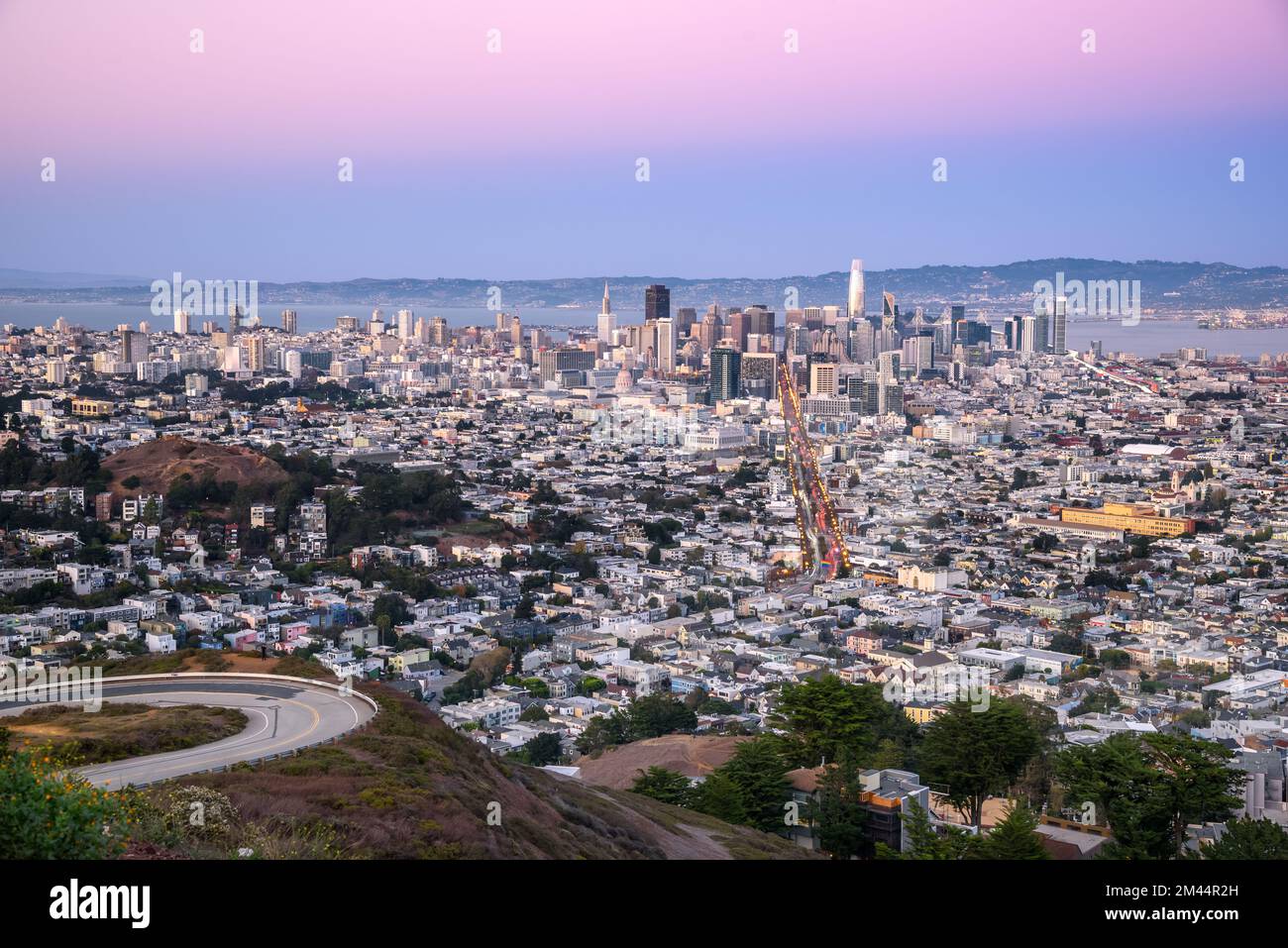 Elevated view of San Francisco skyline under pink sky at dusk in autumn ...