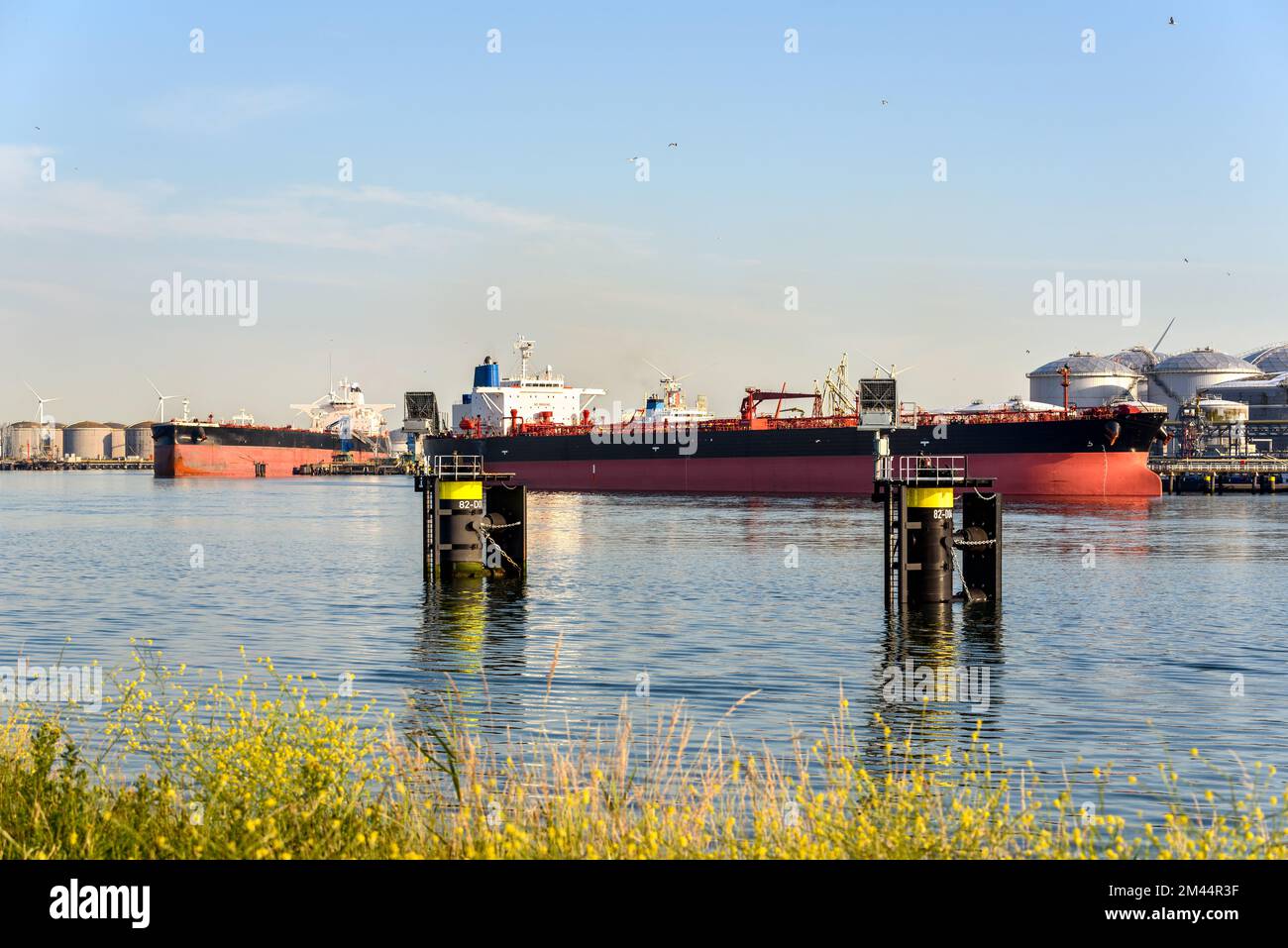 Large tanker ships being unloaded in a oil terminal at sunset Stock ...
