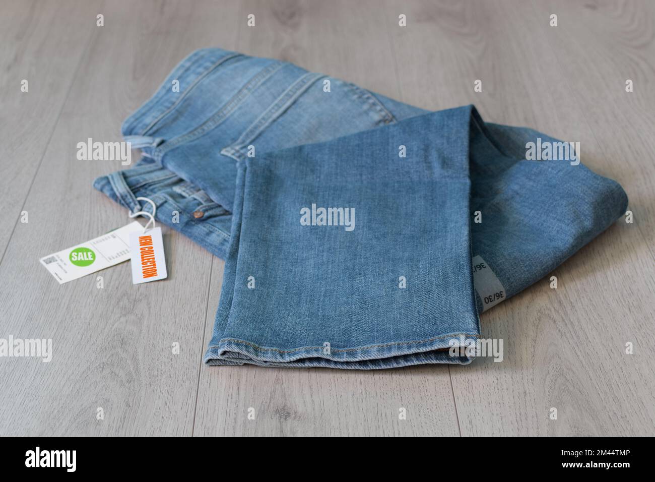 New jeans with inscription on the label - sale. Texture soft background ...