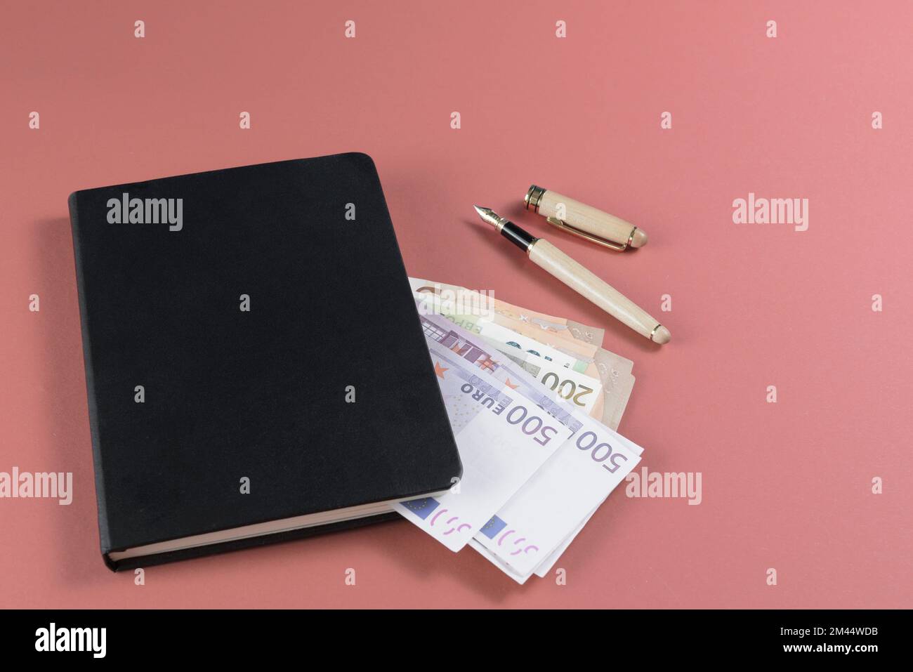 Cash counting. Accounting black book, euro banknotes and fountain pen ...