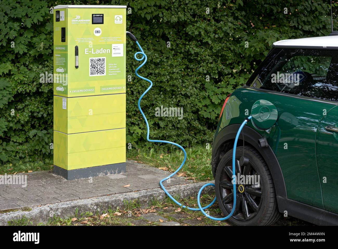 Car park with charging station, car, mini, electric car is charged at ...