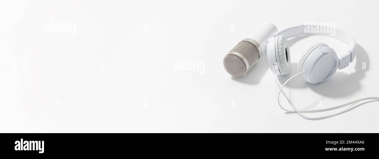 White headphones and microphone for sound recording. banner. on a white ...