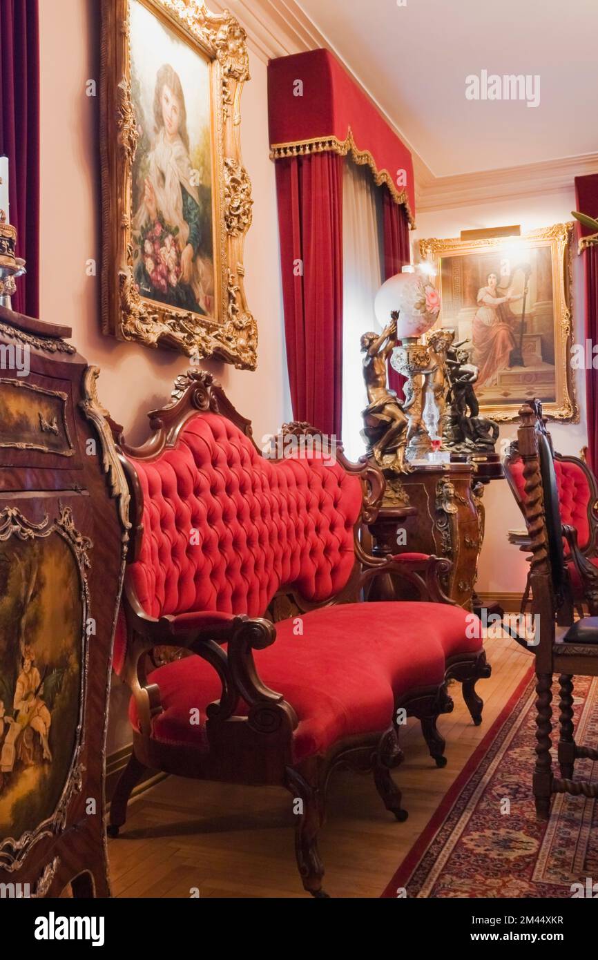 Antique furniture and furnishings adorn a living room inside a ...