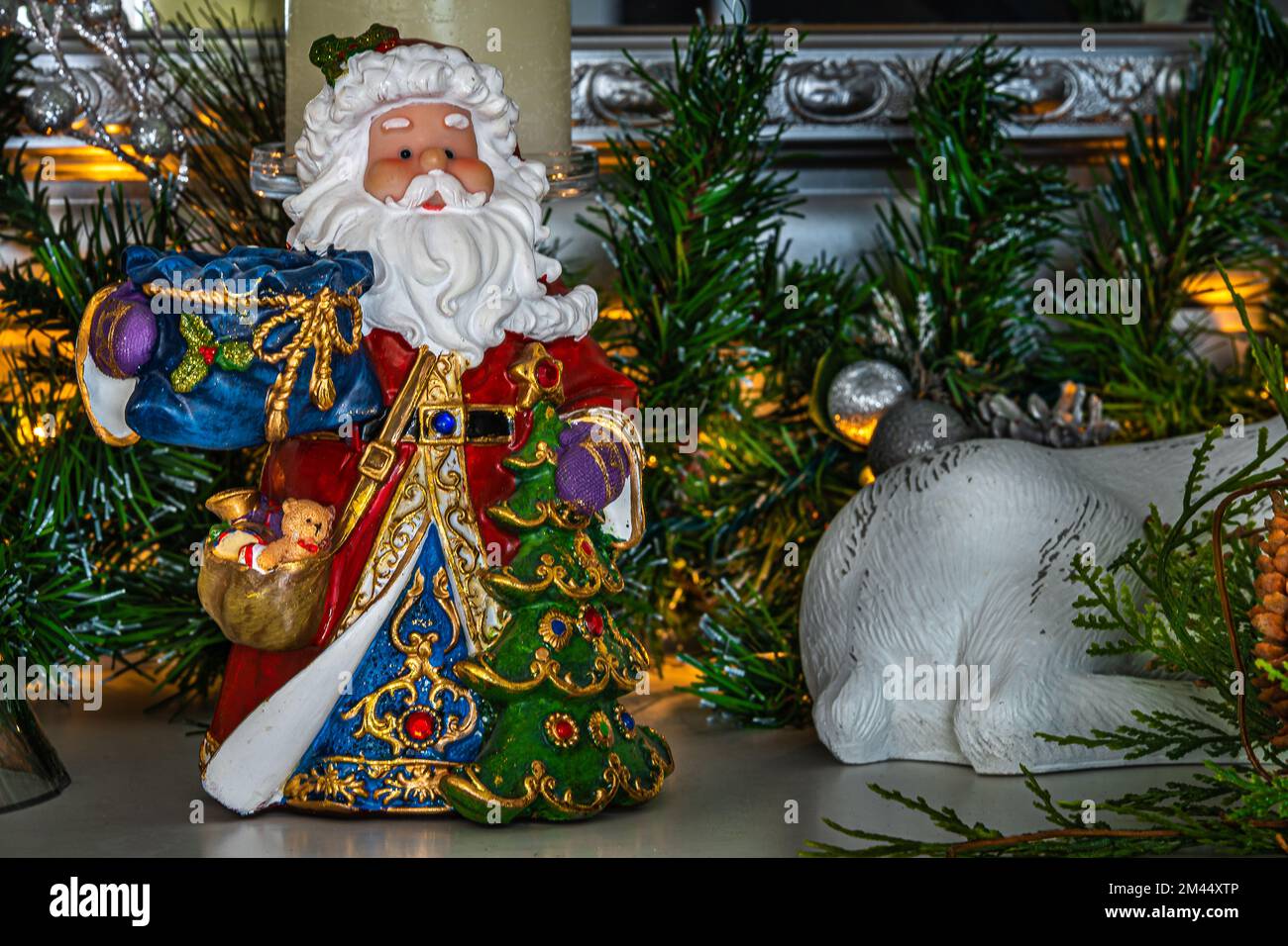 Christmas decorations. Santa Claus on the fireplace among other ...