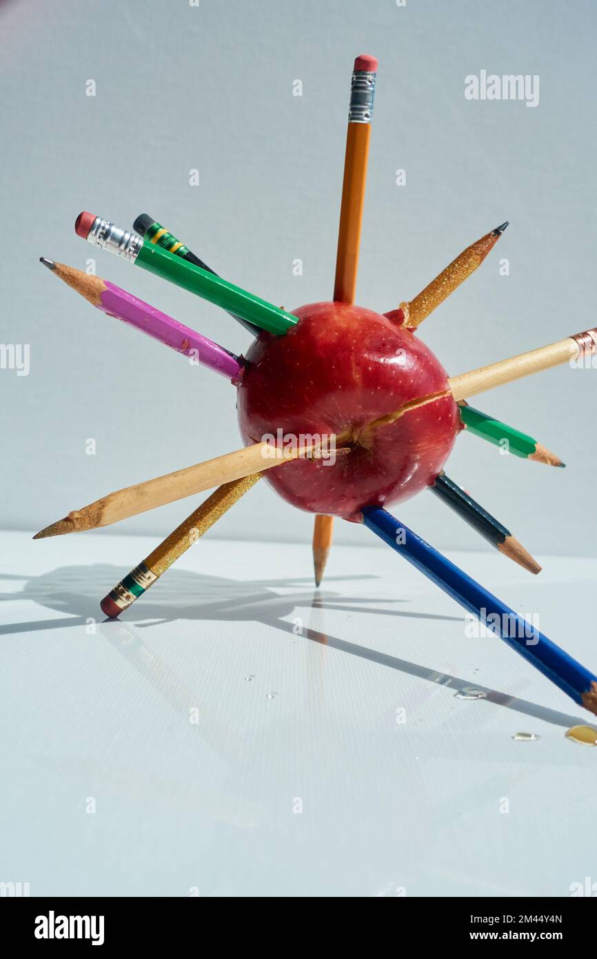 Isolated Red apple skewered with pencils and an empty background Stock ...