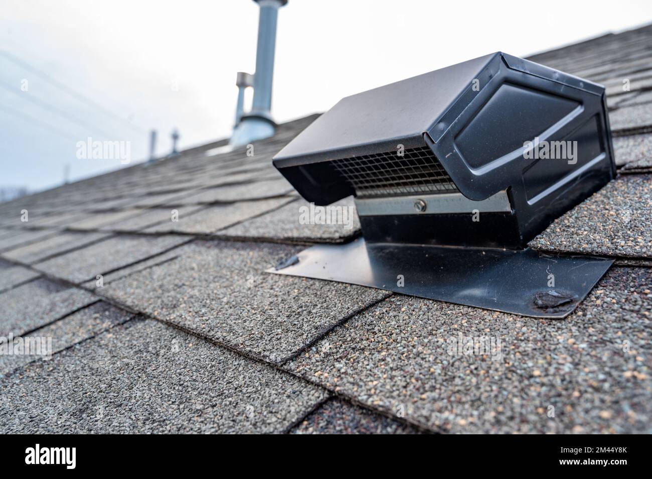 Static vent installed on a shingle roof for passive attic ventilation ...