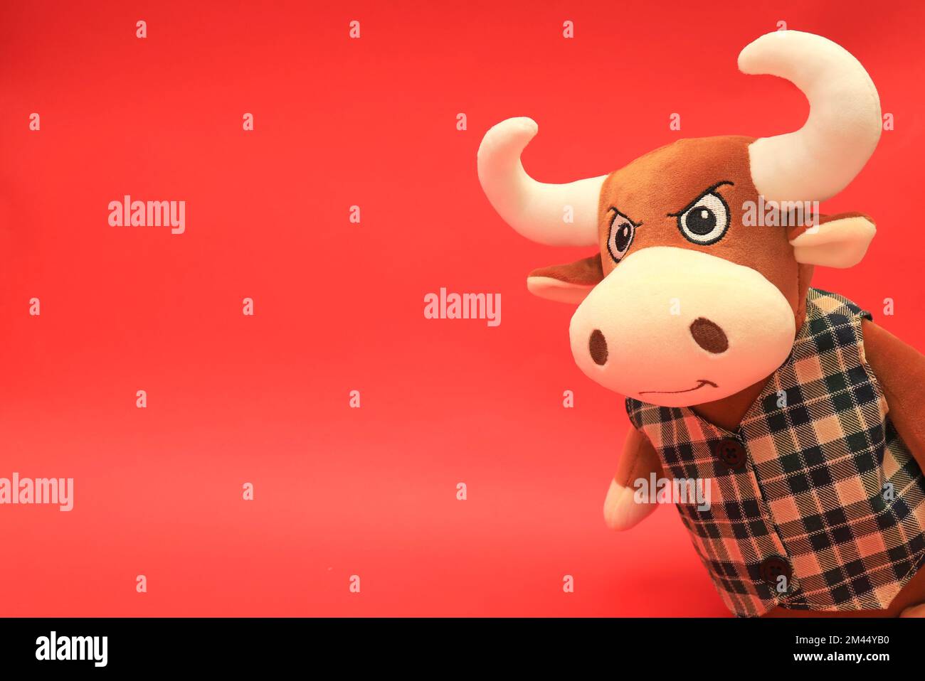 Funny toy orange bull on a red background. Beautiful bull with big ...